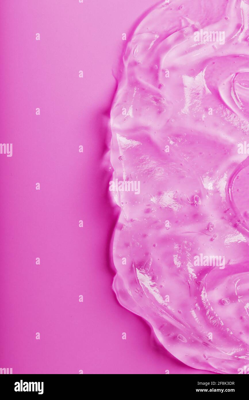 Transparent liquid gel on a pink background with free space. Antiseptic ...