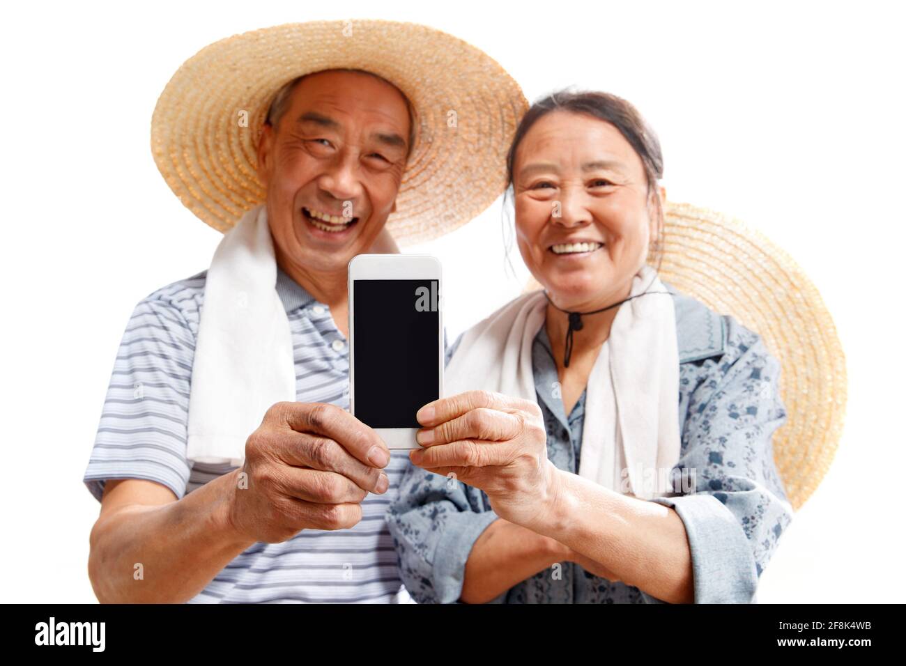 With mobile phone couple of farmers Stock Photo - Alamy