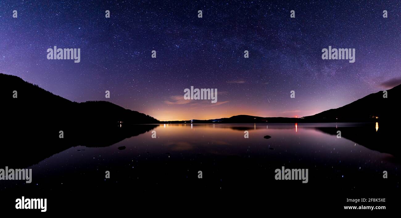A View of Bassenthwaite lake at night with a faint milky way arching ...