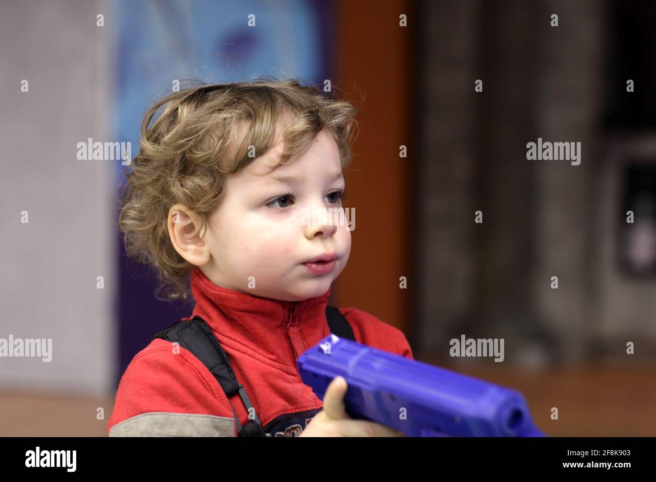 Toddler aiming toy gun hi-res stock photography and images - Alamy