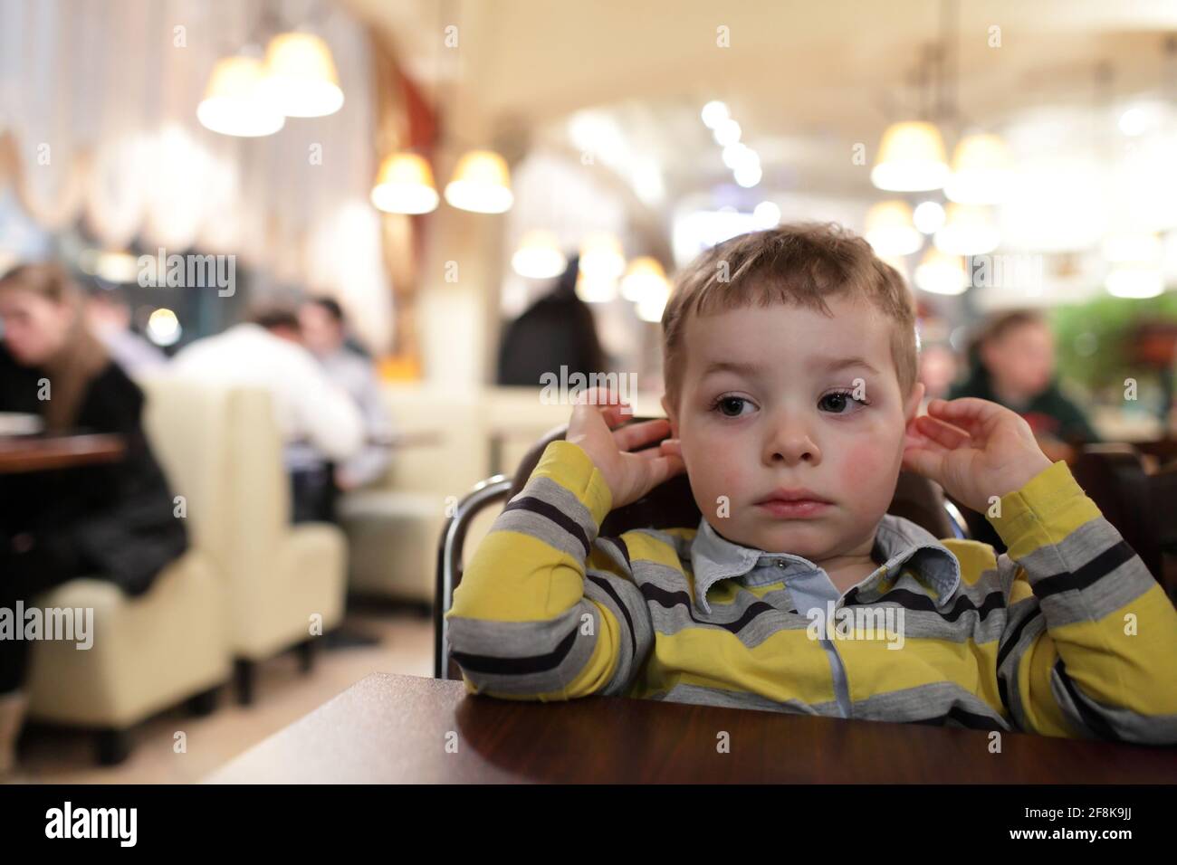 Portrait of pensive child at a cafe Stock Photo - Alamy