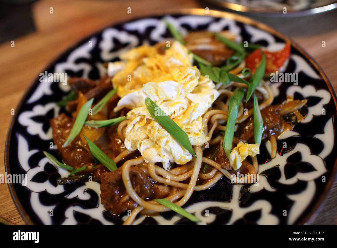 Uzbek lamian noodles fried with vegetables and lamb Stock Photo - Alamy