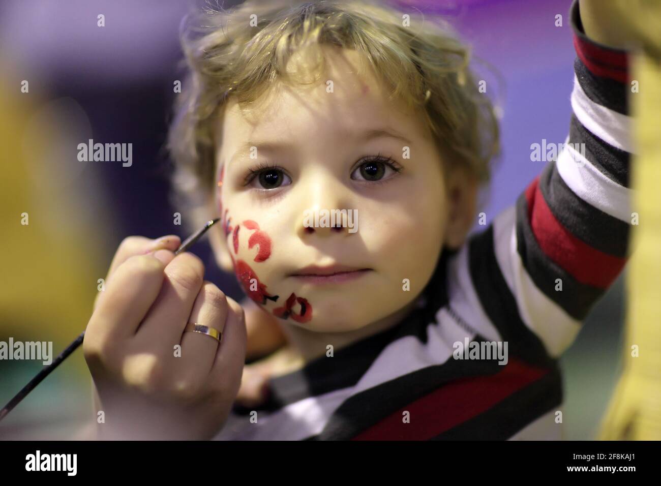 Portrait of kid with painted face indoor Stock Photo - Alamy
