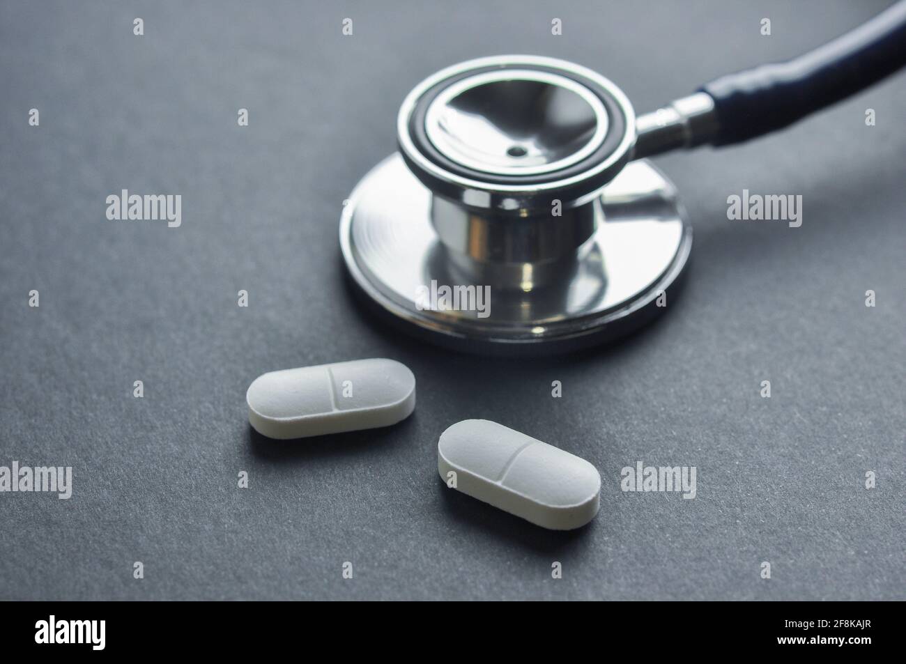 Stethoscope and Pills on a black surface. Diagnosic and Treatment ...