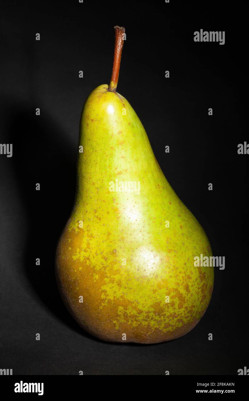 green pear on black background Stock Photo - Alamy