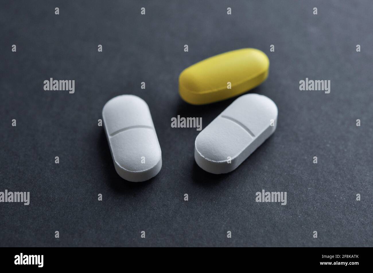 Three Tablets on black background. Medication concept Stock Photo - Alamy