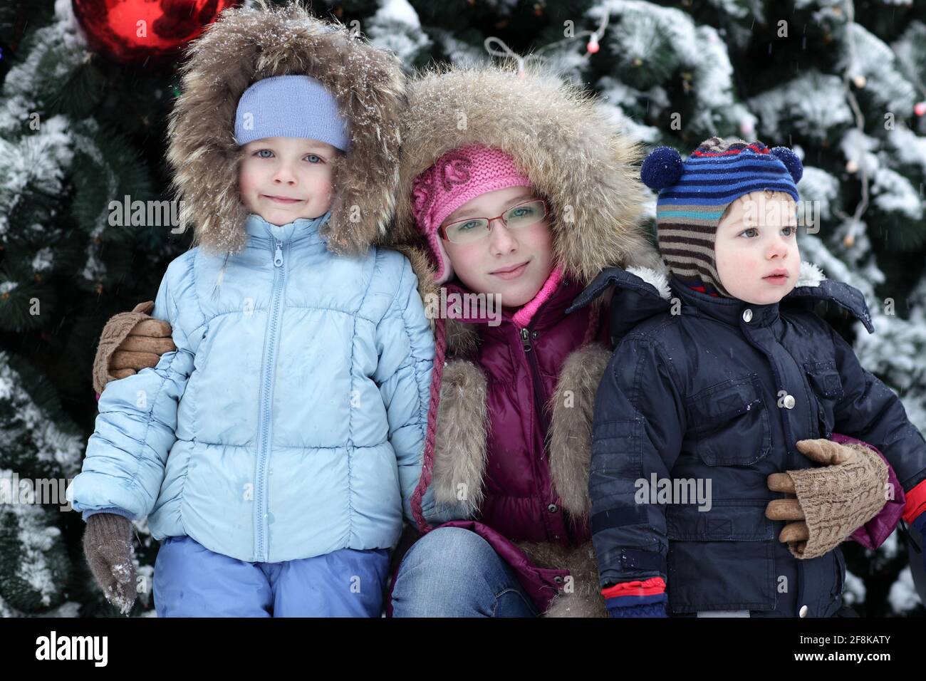 Portrait of children on the Christmas tree background Stock Photo - Alamy