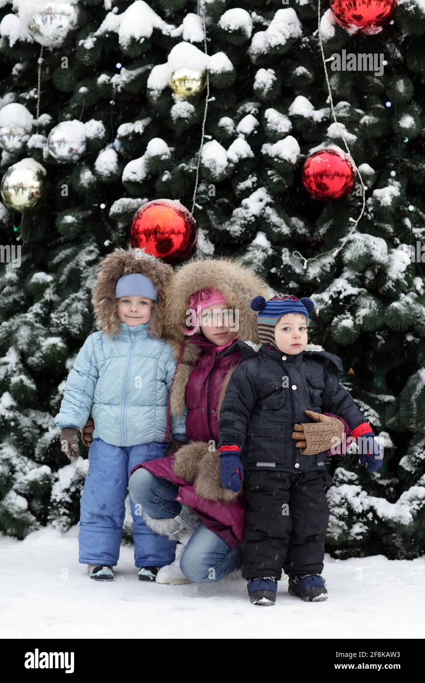 Children posing on the Christmas tree background Stock Photo - Alamy