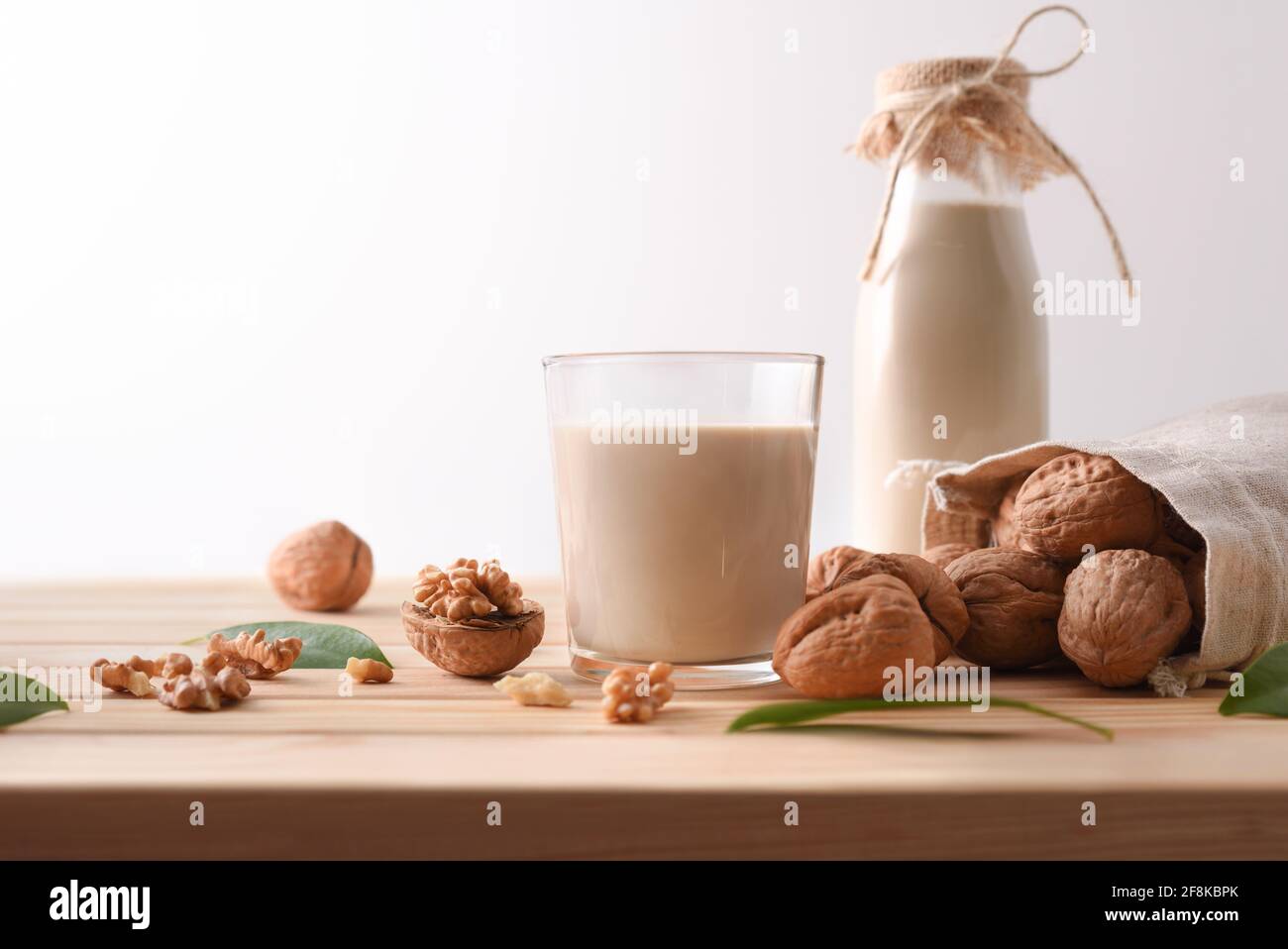 Glass of alternative vegetable drink of walnuts with fruits on the ...