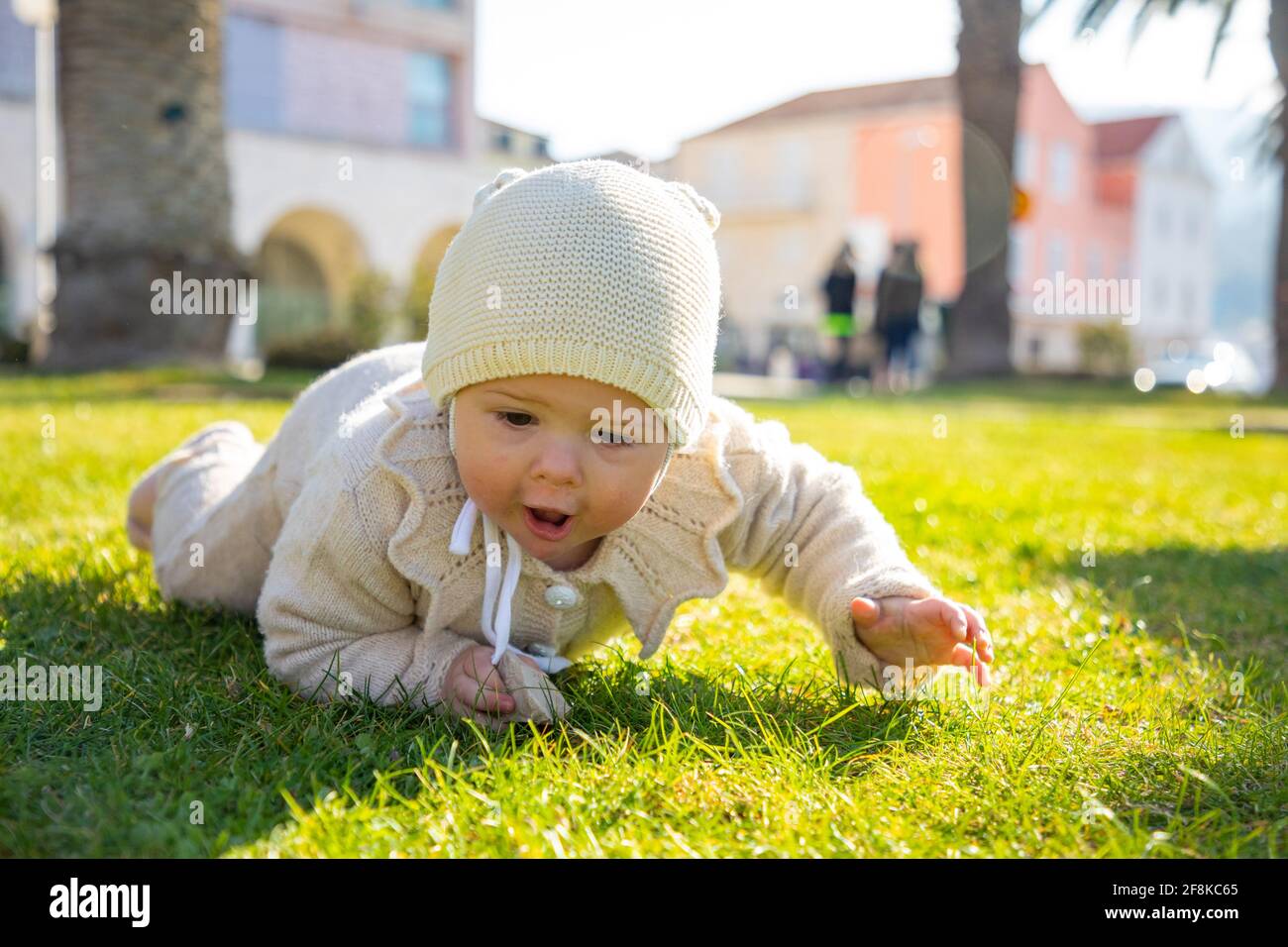 Cute baby girl outdoor in spring time on grass Stock Photo - Alamy