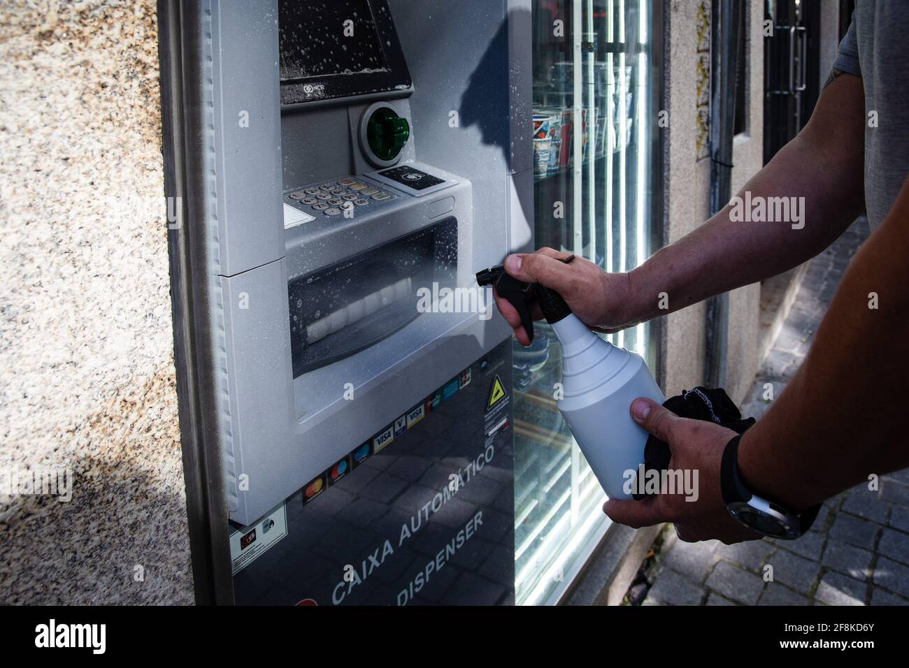 A man seen disinfecting an ATM machine, due to the covid-19 in Porto ...