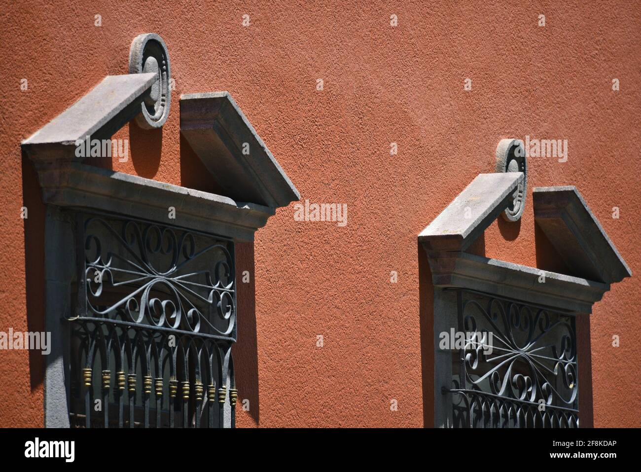 Colonial style building facade with stone crafted details on a stucco ...