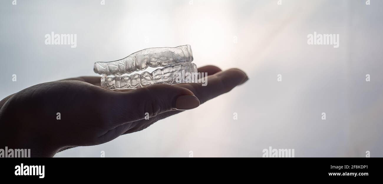 Transparent trays for correcting teeth in female hands. Removable ...