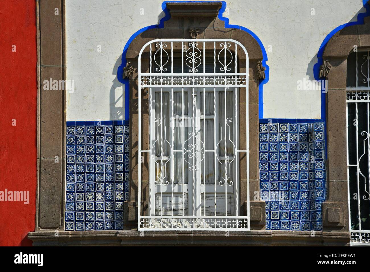 Colonial style building facade with a Talavera tile wall and a window ...