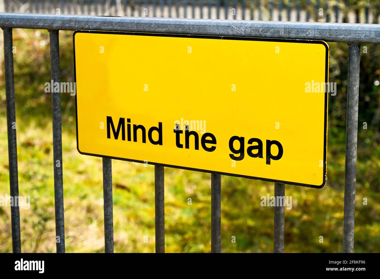 Mind the Gap sign at a railway station Stock Photo - Alamy