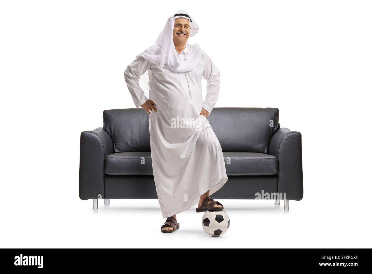 Full length portrait of a arab man in a thobe with a soccer ball ...