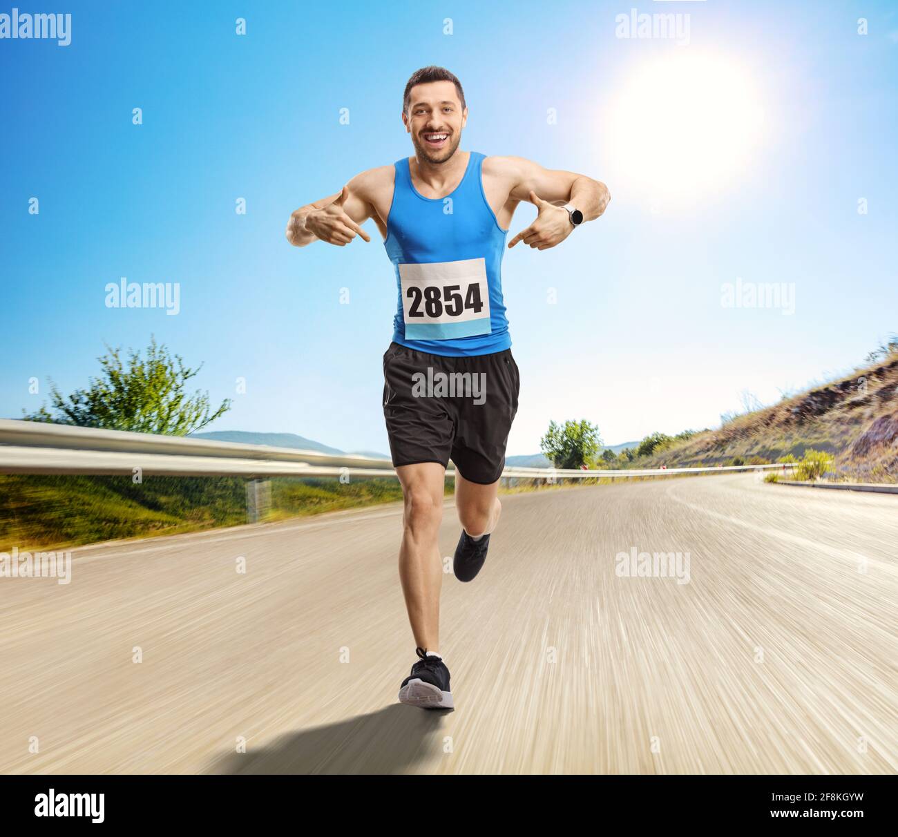 Full length portrait of a man running a marathon and pointing at his ...