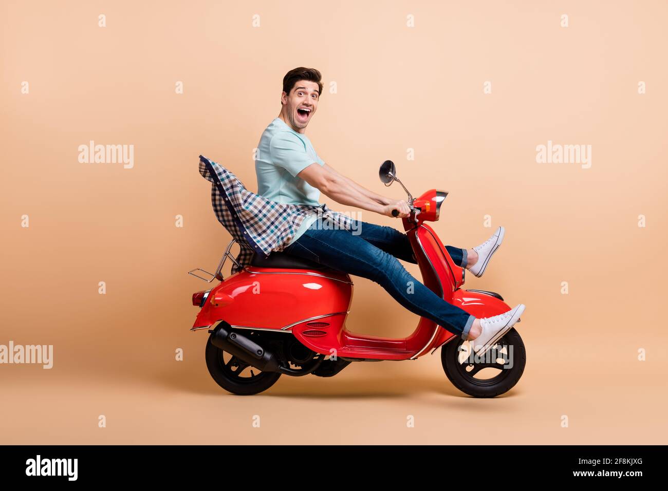 Profile side view portrait of nice funky cheerful guy driving moped ...