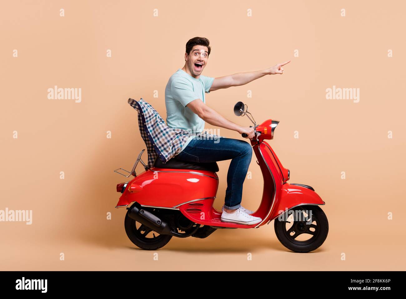 Profile side view portrait of nice amazed cheerful guy driving moped ...