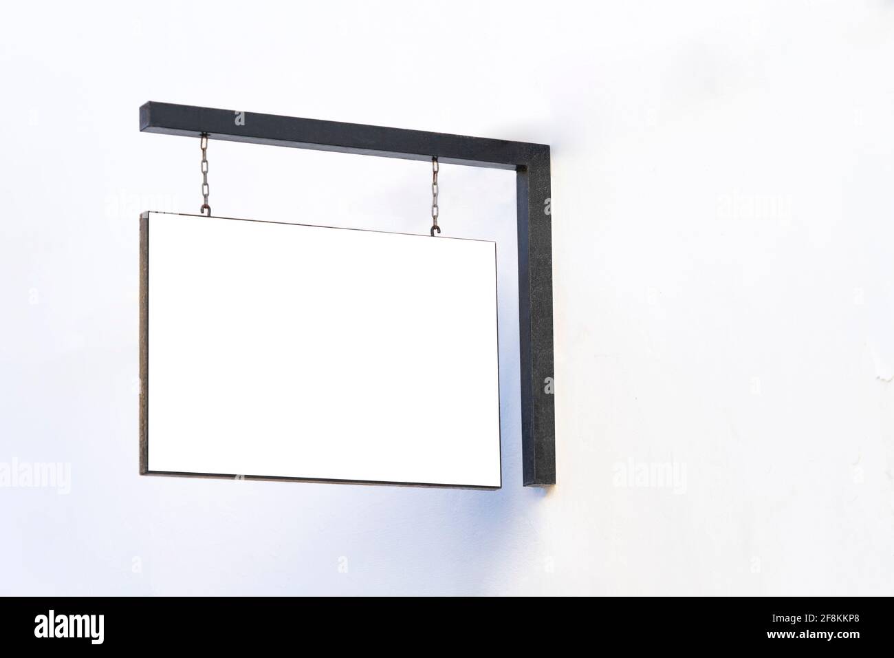 Horizontal signboard or signage on white wall with blank white sign ...