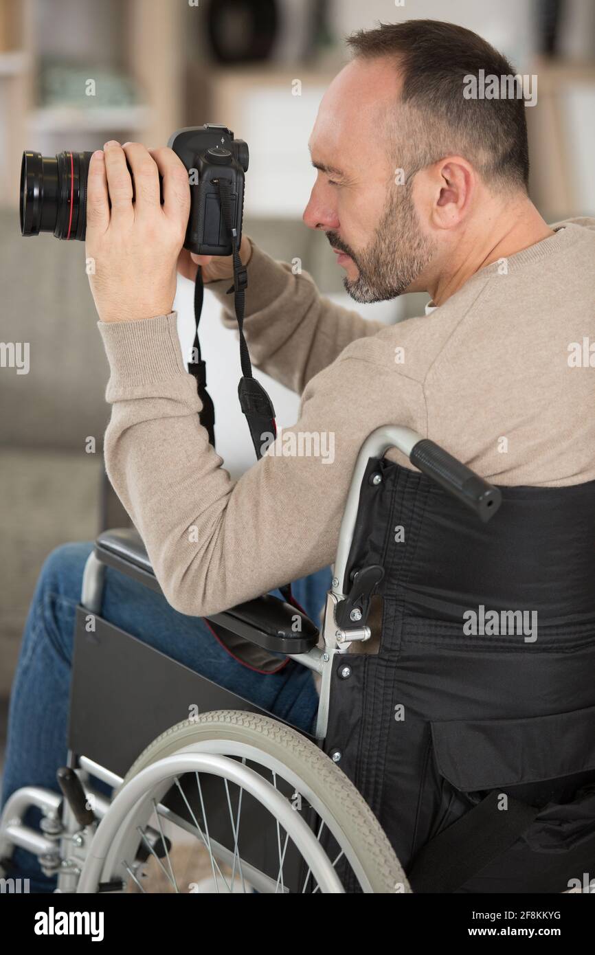 disable man with a camera on a selfie stick Stock Photo - Alamy