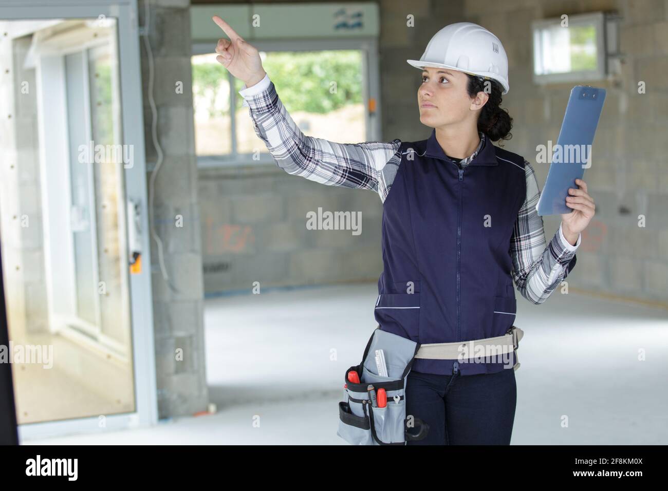 construction worker pointing out final retouches Stock Photo - Alamy