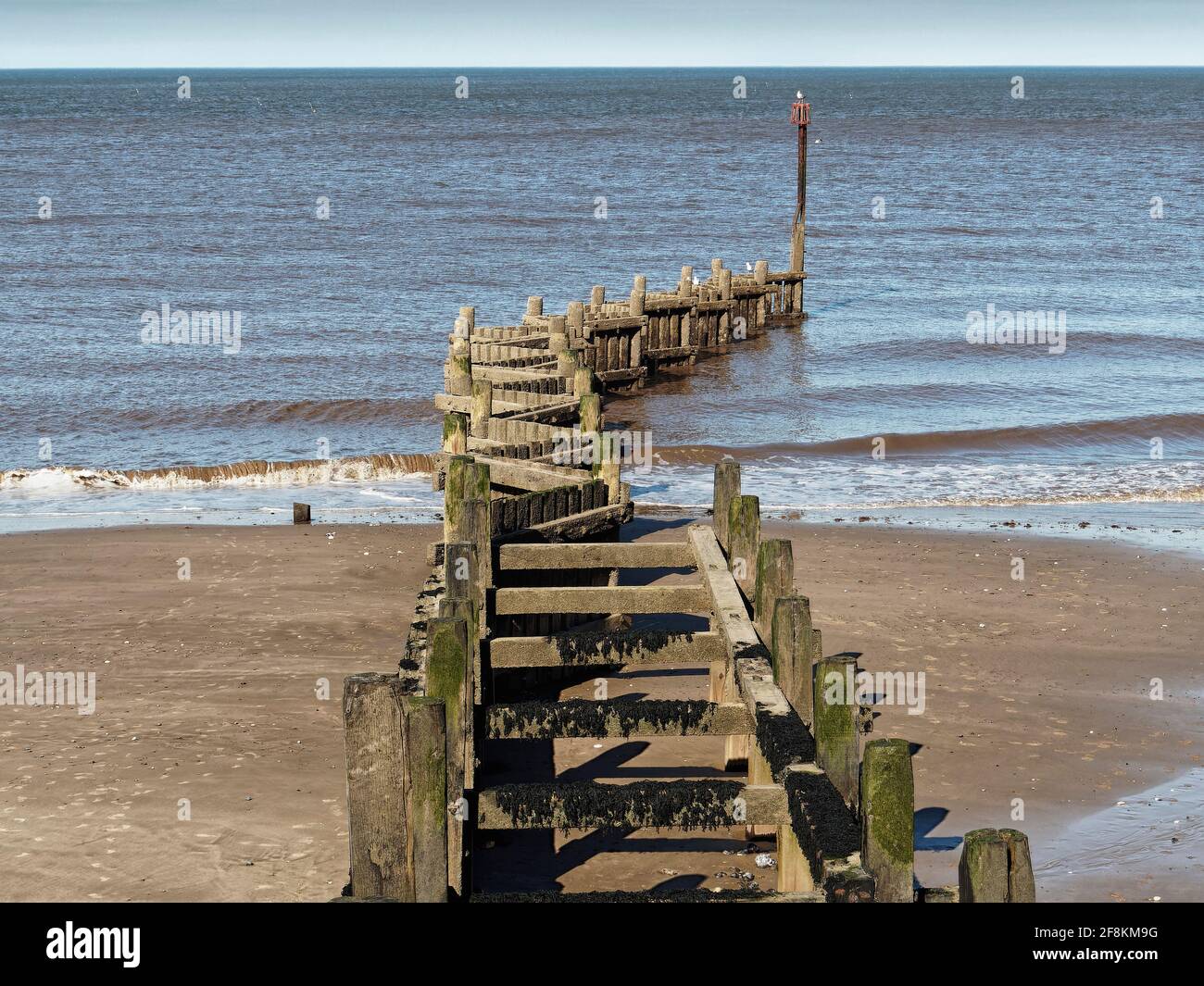 Sea defences protecting the beach and cliffs at the popular residential ...