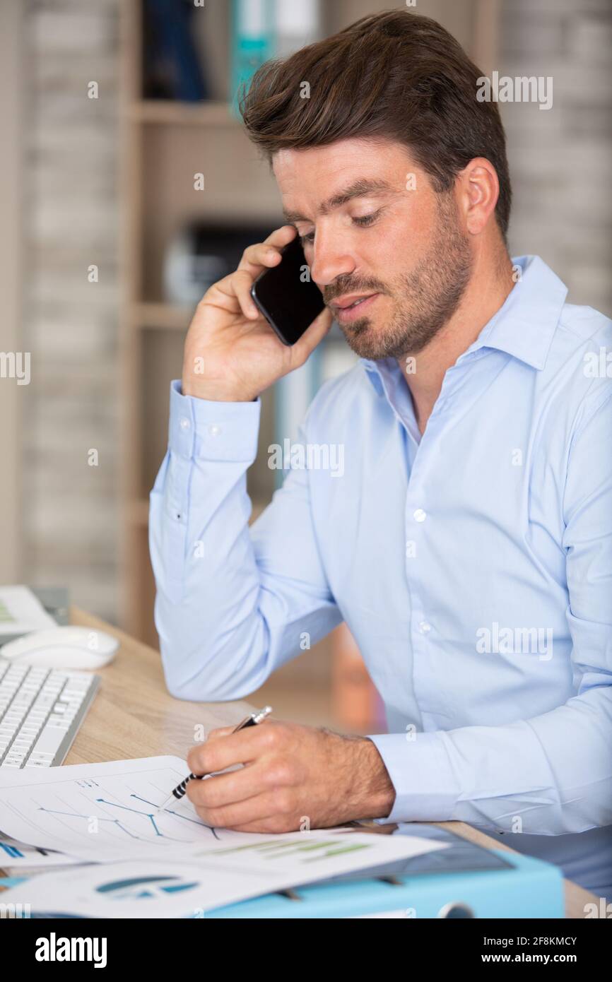 happy entrepreneur at his desk in office Stock Photo - Alamy