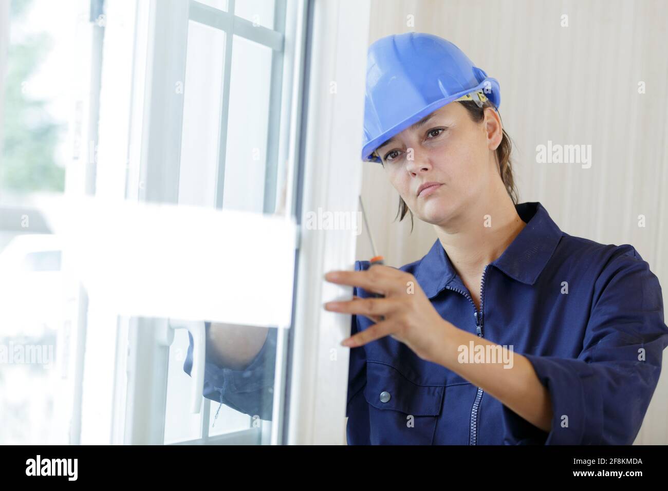 female window fitter at work Stock Photo - Alamy