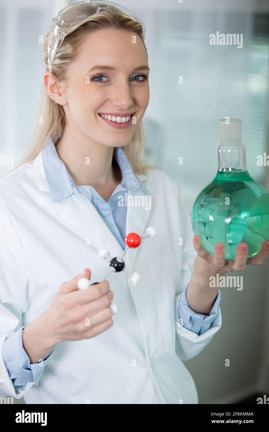 young attractive female scientist working with liquid Stock Photo - Alamy