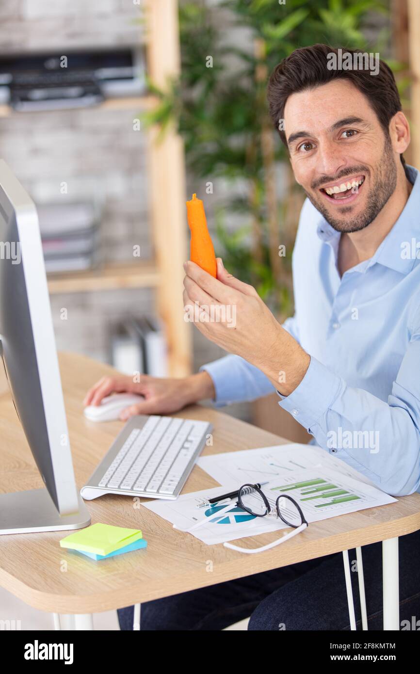 happy office worker eating healthy Stock Photo - Alamy