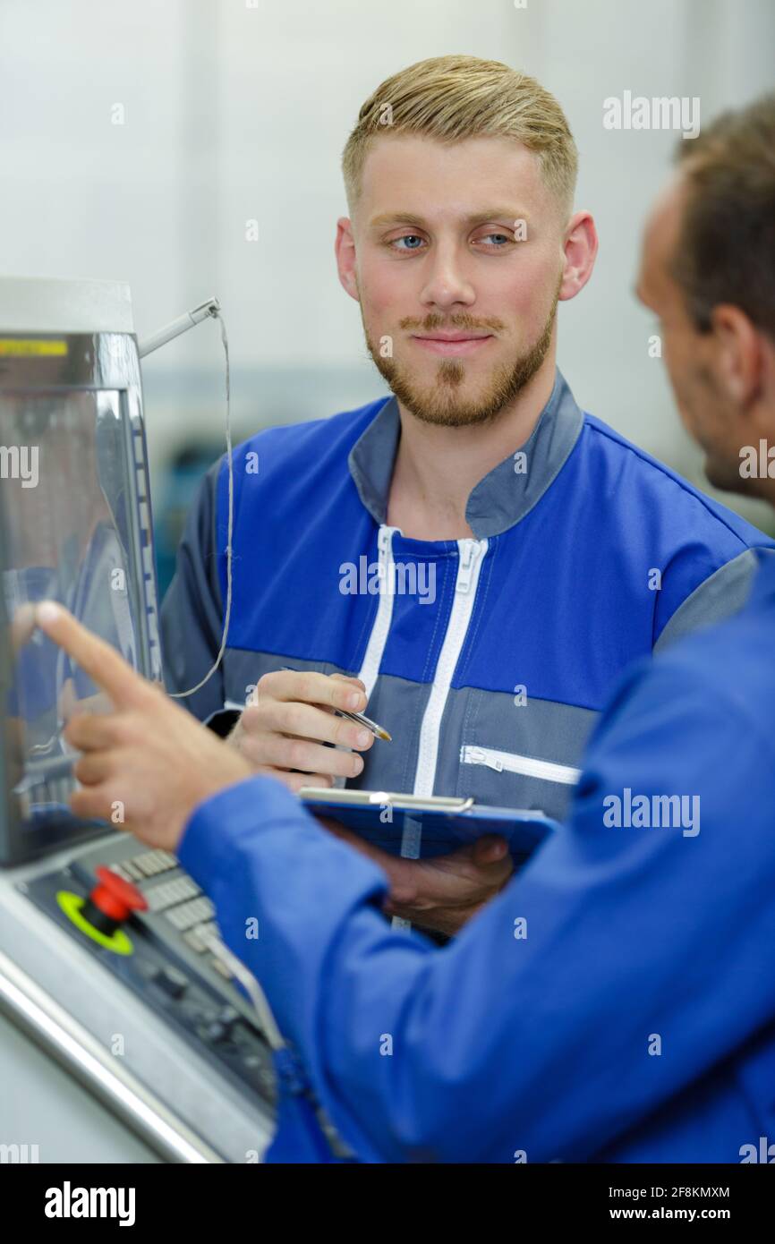 men operating machines in factory Stock Photo - Alamy
