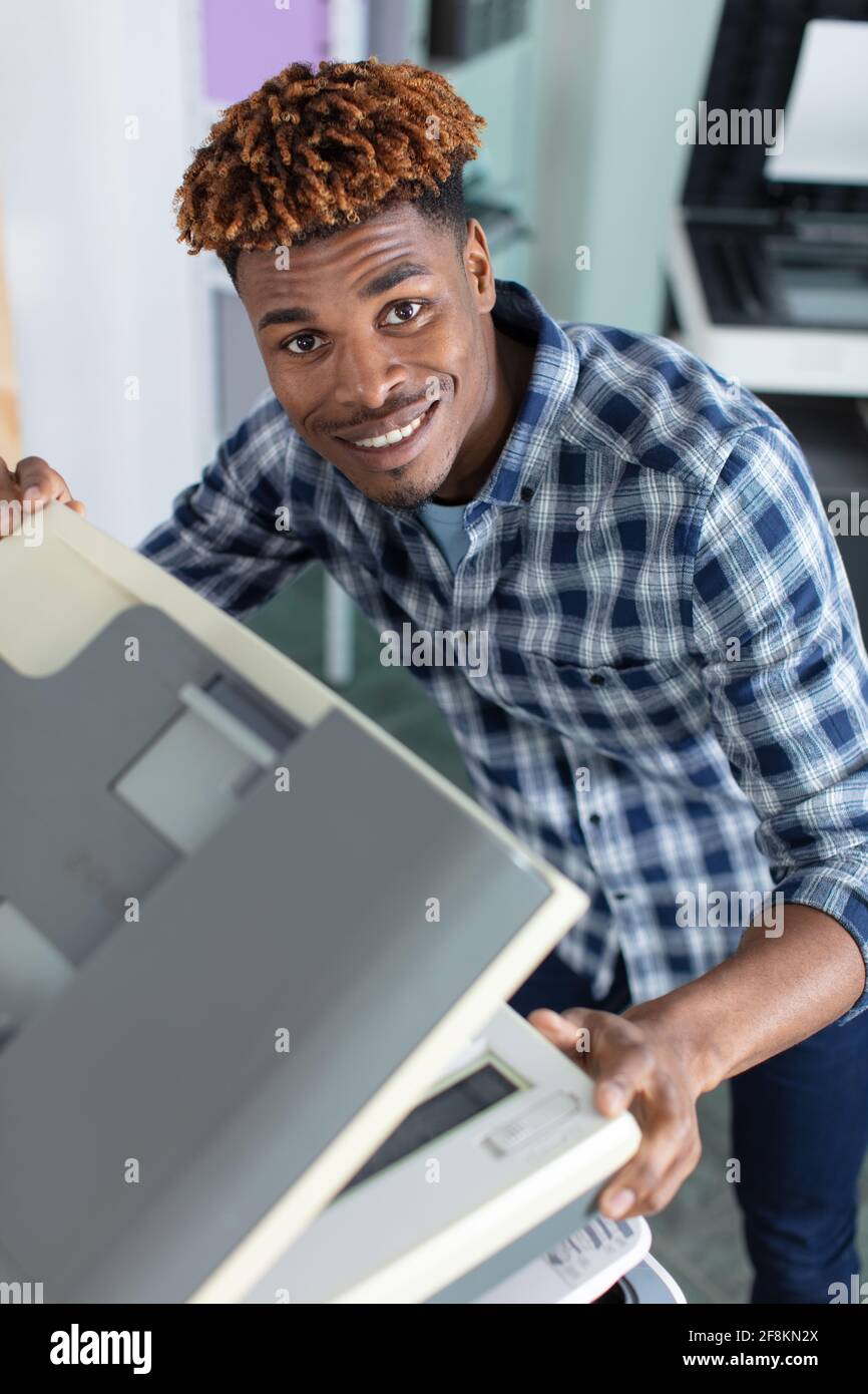 happy young man is fixing a printer Stock Photo - Alamy