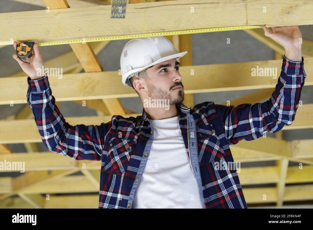 a man measuring wood frame Stock Photo - Alamy
