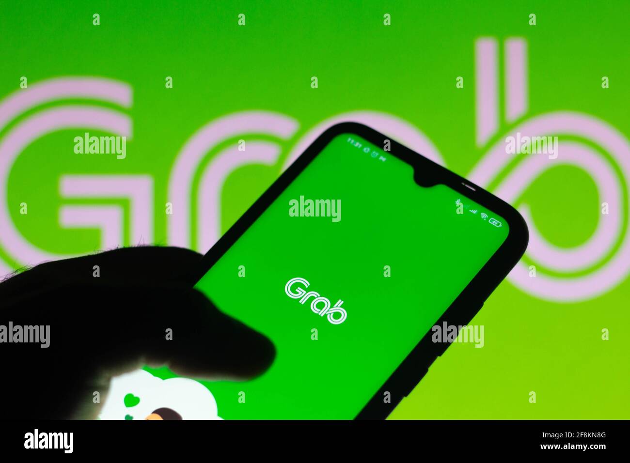 In this photo illustration, the Grab Holdings logo seen displayed on a ...