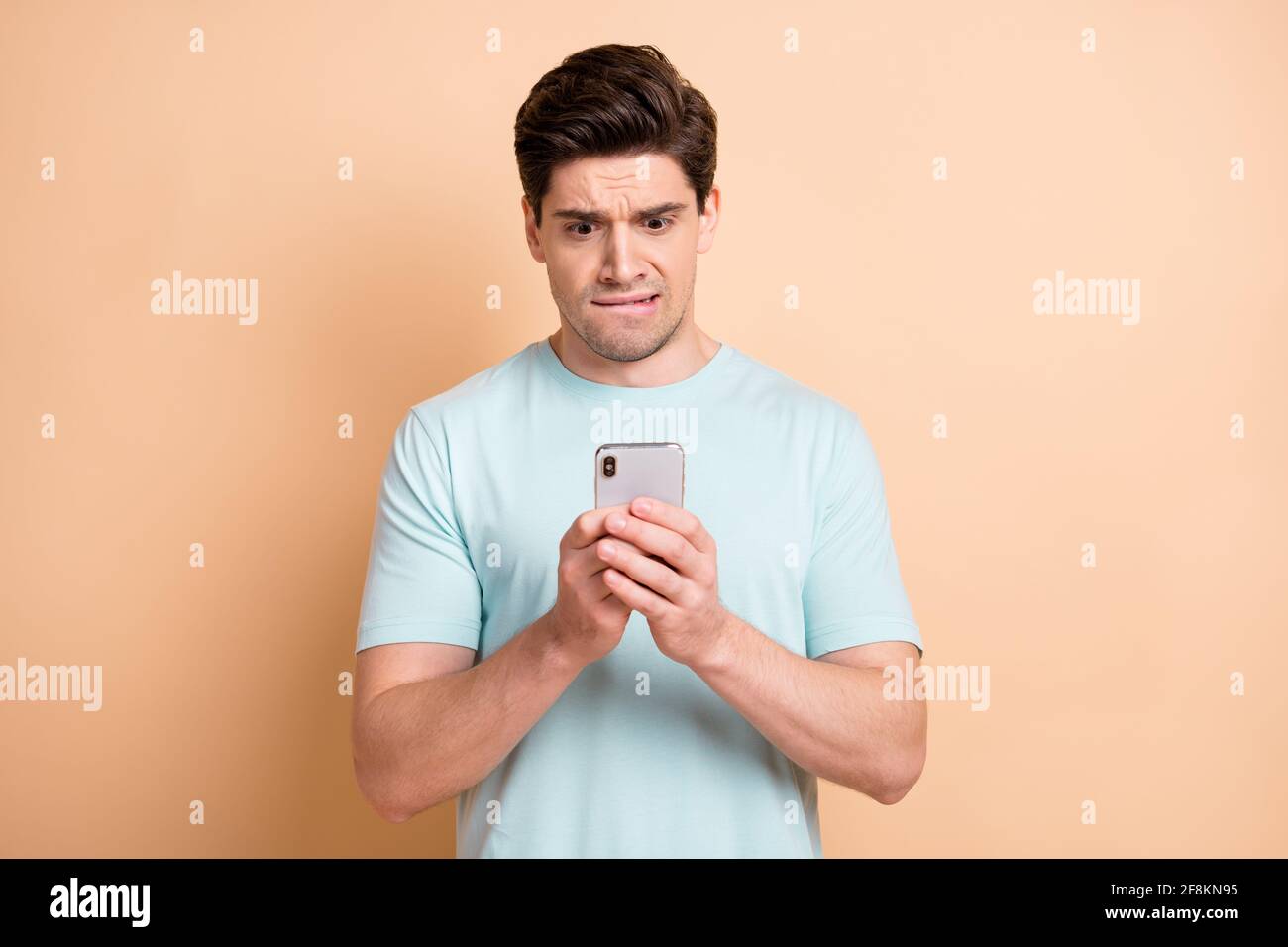 Man biting lip phone hi-res stock photography and images - Alamy