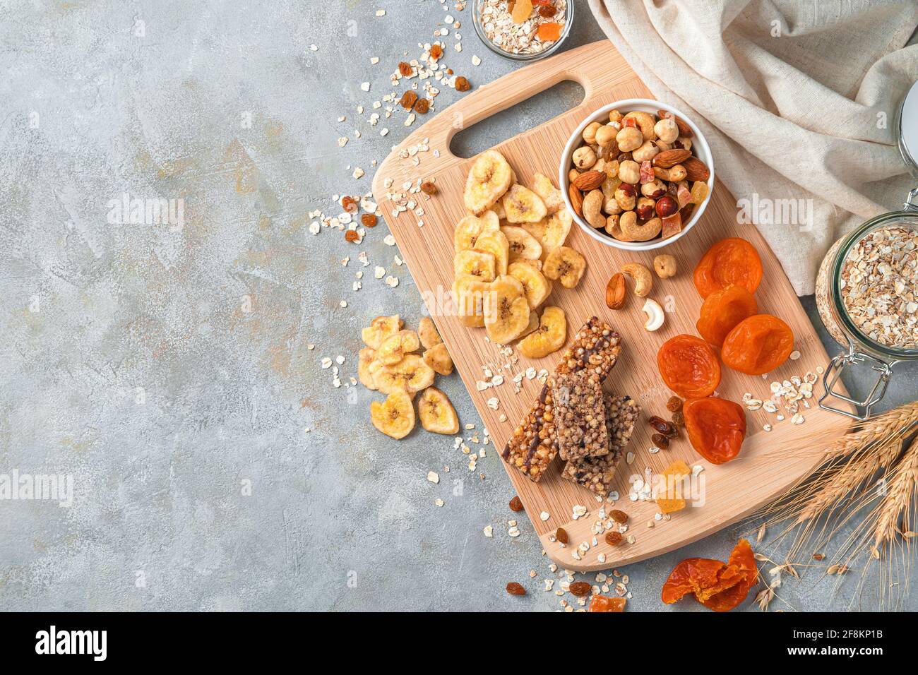 Vitamin-rich, healthy natural sweets on a gray background. Granola bar ...