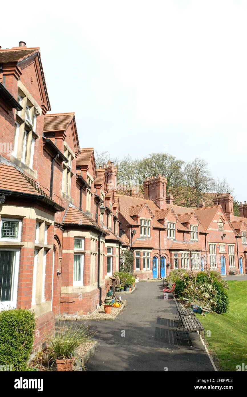 19th century red-brick former alms houses with distinctive chimney ...