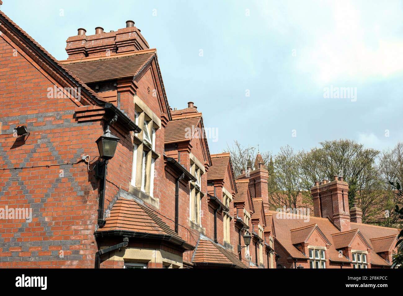 19th century red-brick former alms houses with distinctive chimney ...