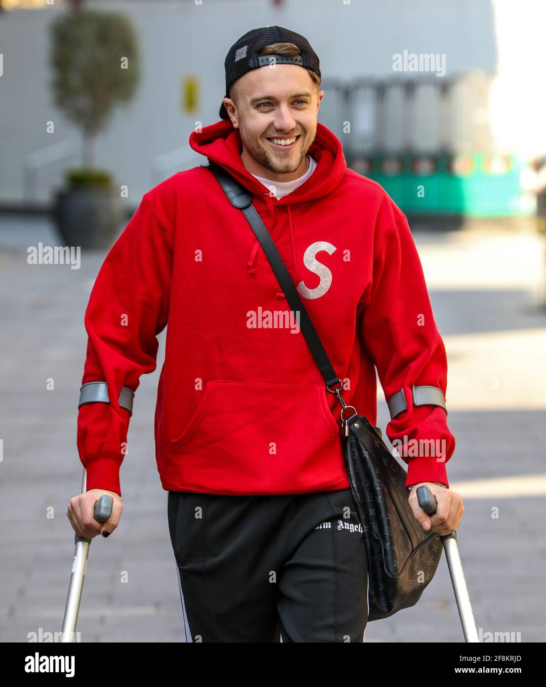 London, UK. 14th Apr, 2021. Roman Kemp in his crutches seen departing ...