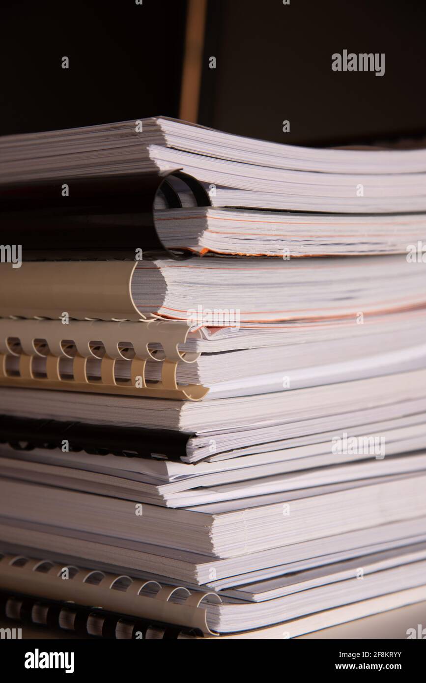 Stack of reports lies on a desk ready for review Stock Photo - Alamy