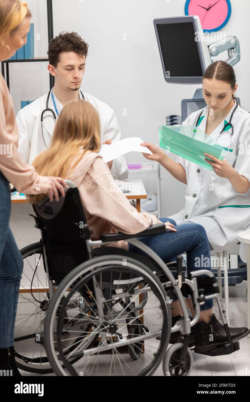 A Wheelchair Bound Teenager And Her Mother Wait In A Doctors Office A