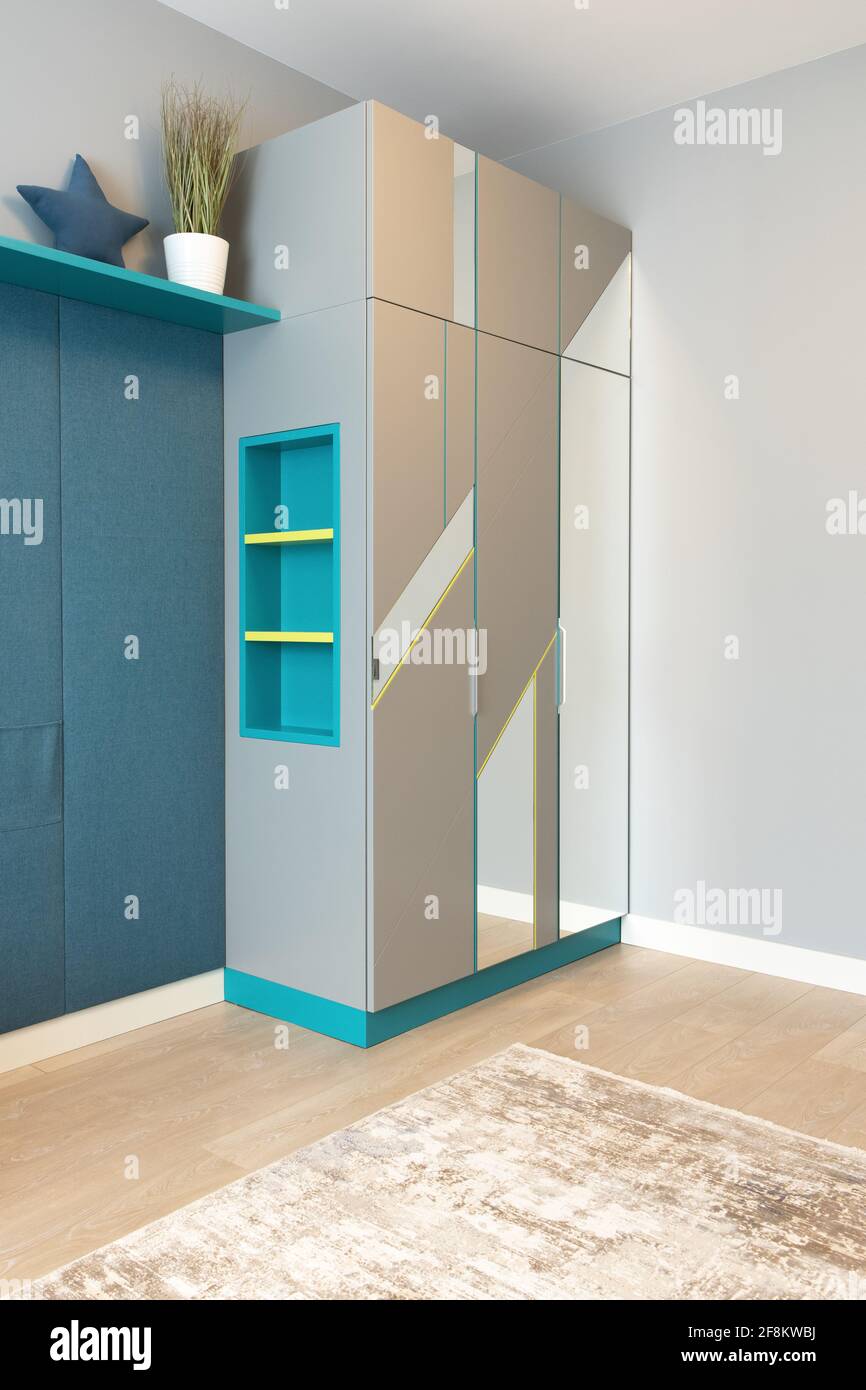 A gray wardrobe with niche shelves, with a geometric pattern on the ...