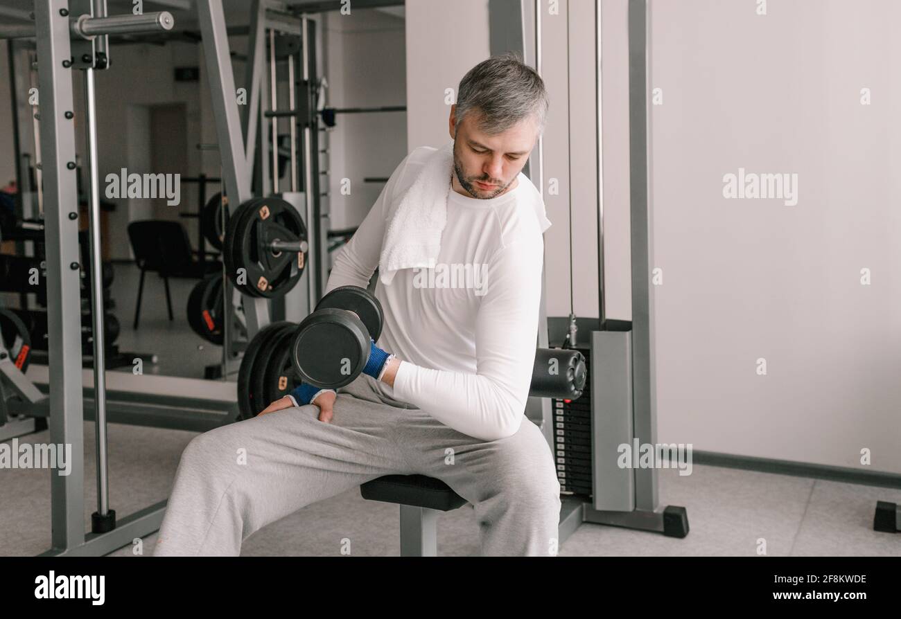 Attractive bodybuilder sitting on bench hi-res stock photography and ...
