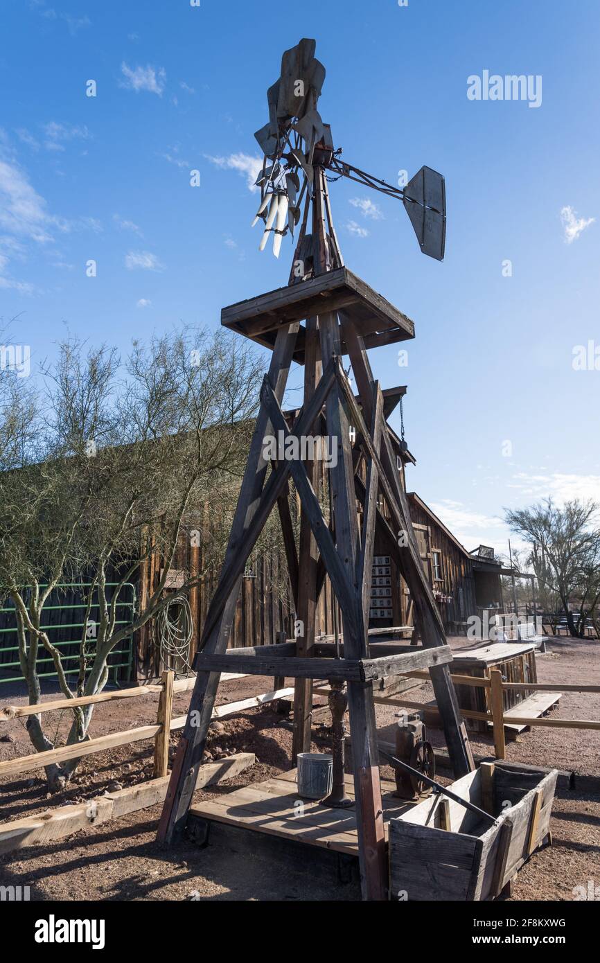 An old pioneer-style windmill or windpump with a wooden tower in the ...