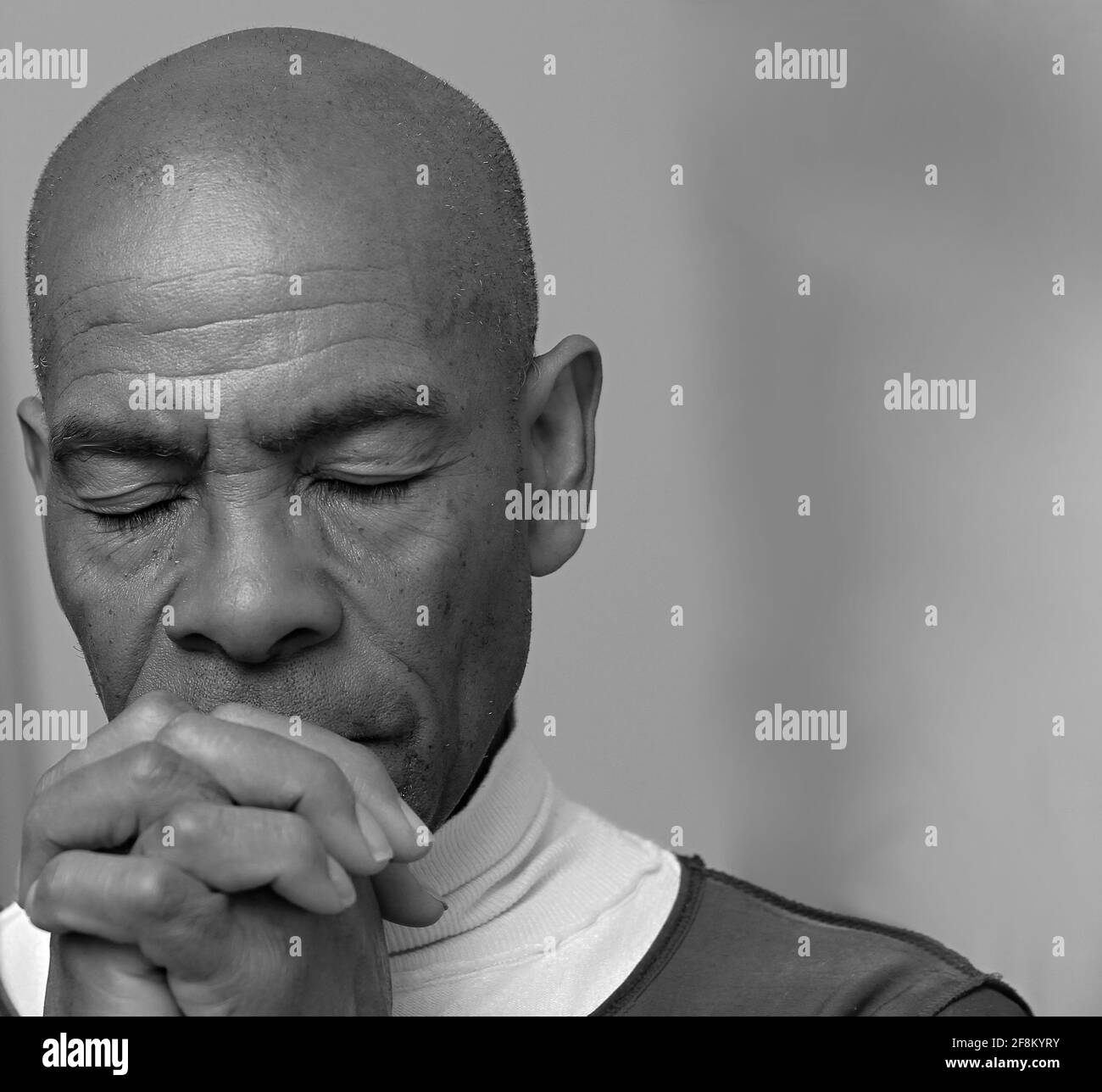 man praying to god with hands together Caribbean man praying stock ...