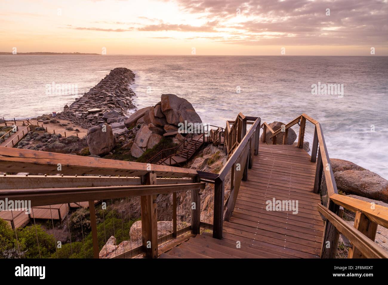 The granite island breakwater and boardwalk at sunrise in Victor Harbor ...