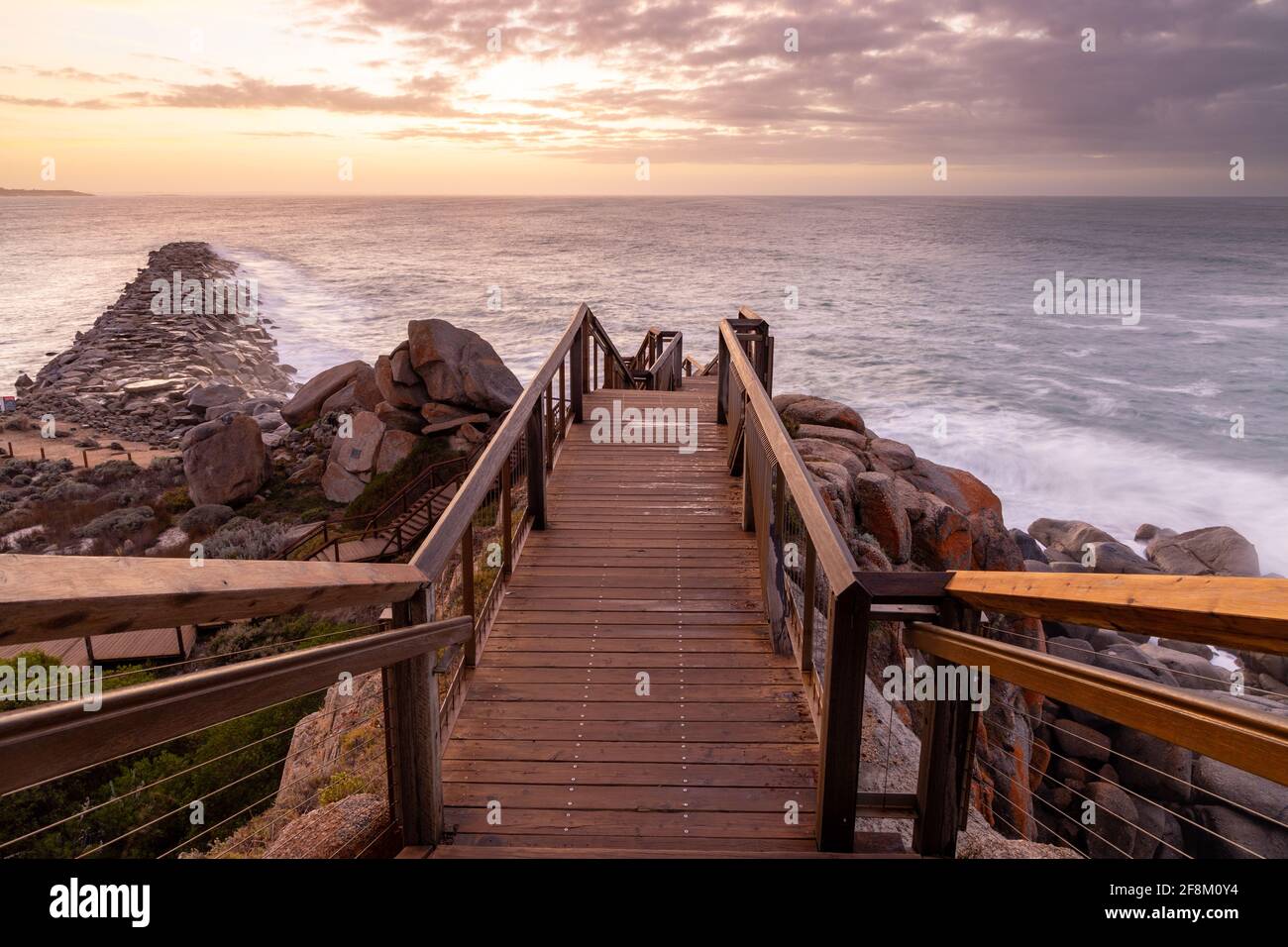 The granite island breakwater and boardwalk at sunrise in Victor Harbor ...