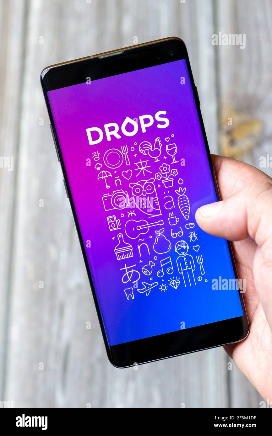 A Mobile phone or Cell phone being held in a hand showing the Drops ...
