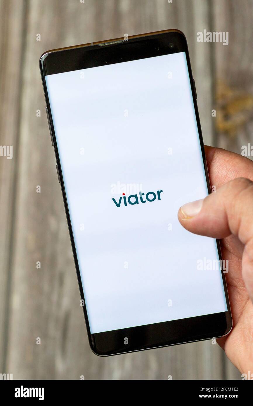 A Mobile phone or Cell phone being held in a hand showing the Viator ...